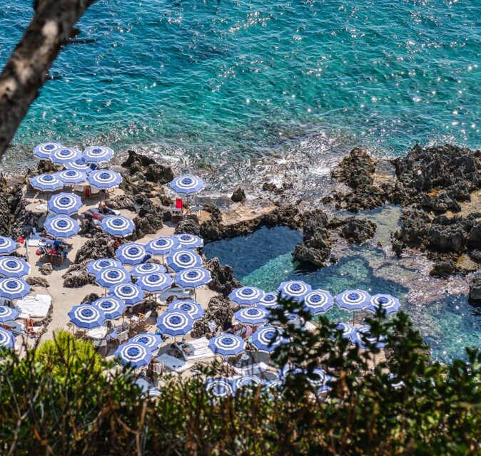 Facing the Faraglioni of Capri, La Fontelina restaurant and beach ...